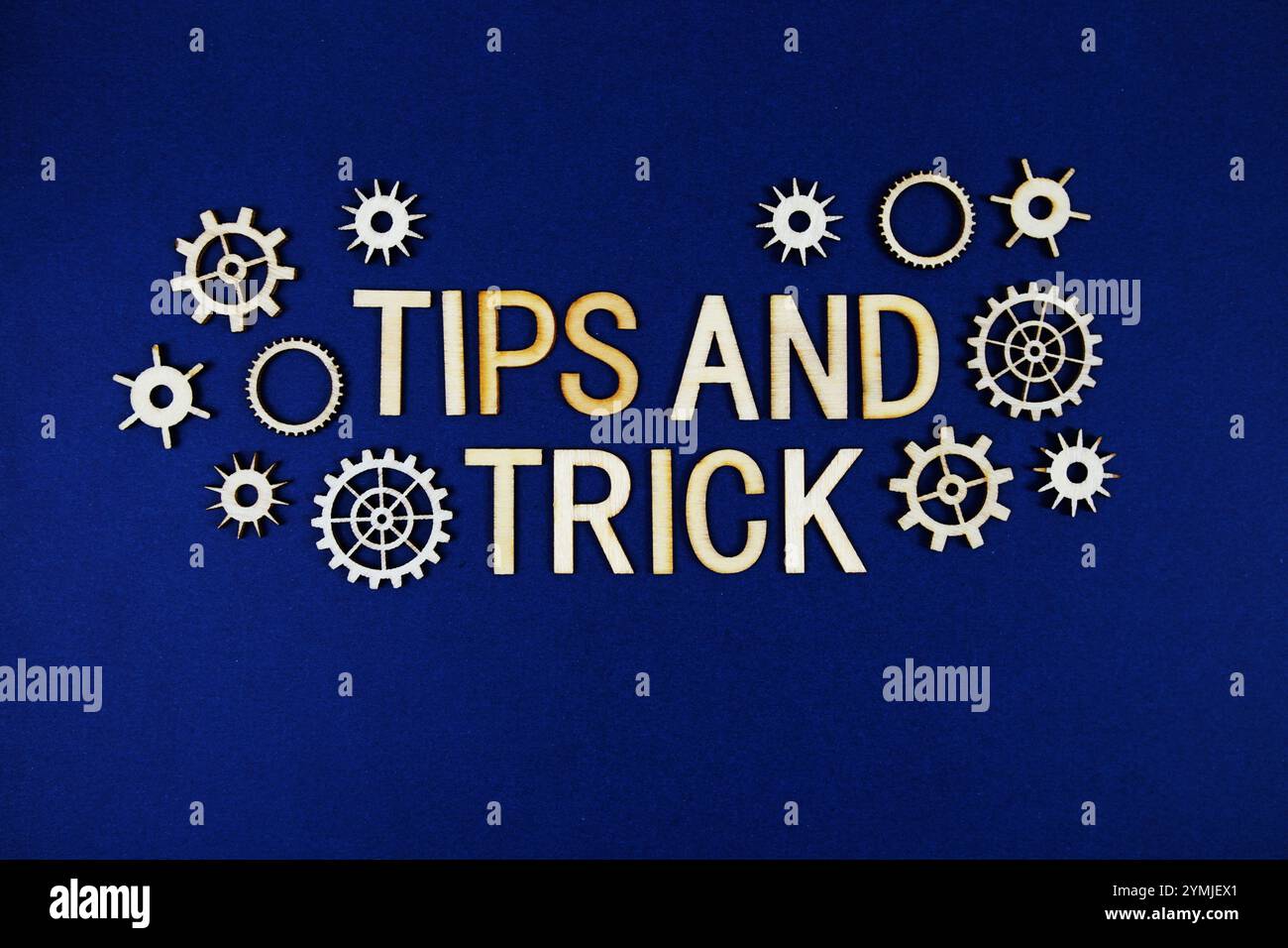 Tips and Trick alphabet letters with gears element on navy blue ...