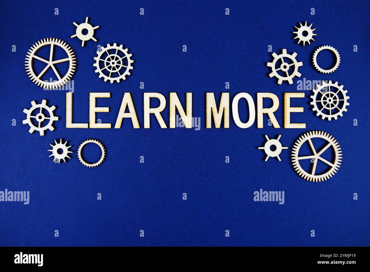 Learn More alphabet letters with gears element on navy blue background ...