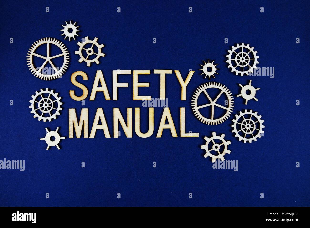 Safety Manual alphabet letters with gears element on navy blue ...