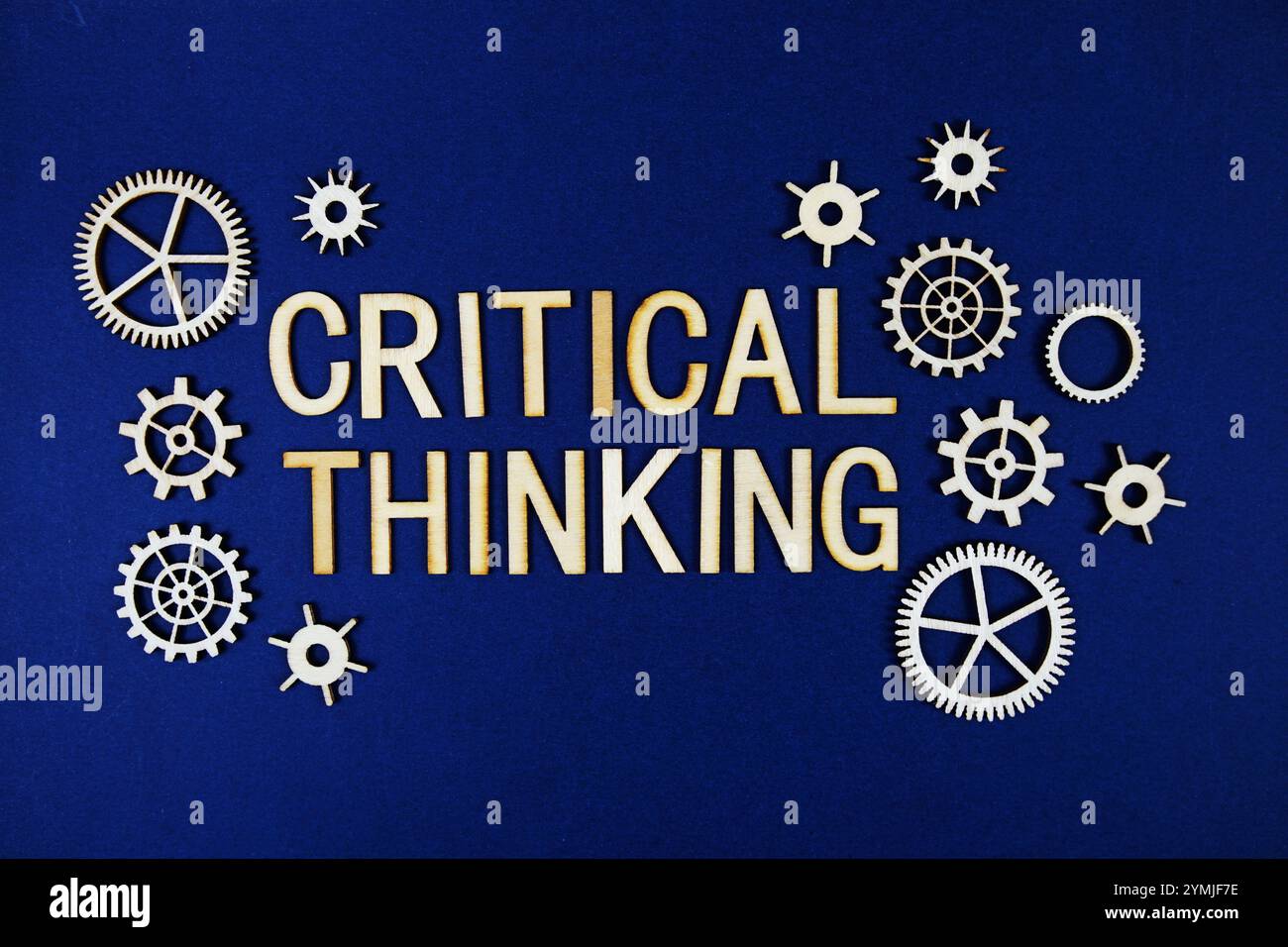 Critcal Thinking alphabet letters with gears element on navy blue ...