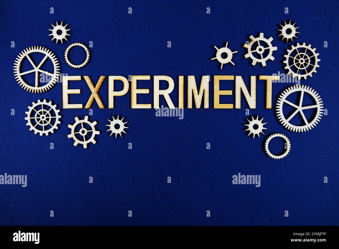 Experiment alphabet letters with gears element on navy blue background ...