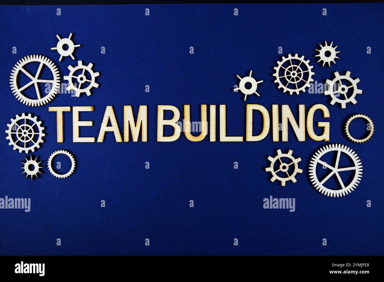 Team Building alphabet letters with gears element on navy blue ...