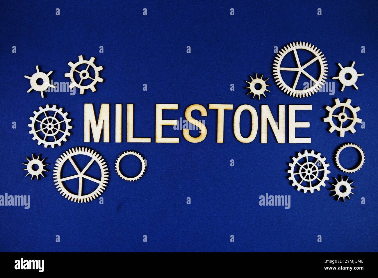 Milestone alphabet letters with gears element on navy blue background ...