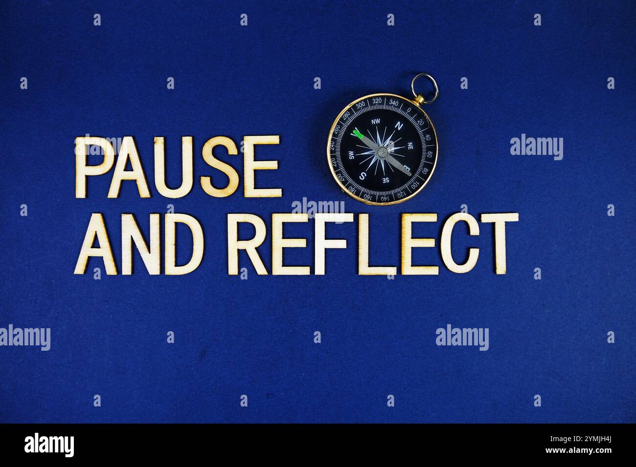 Pause And Relect alphabet letters with compass on navy blue background ...