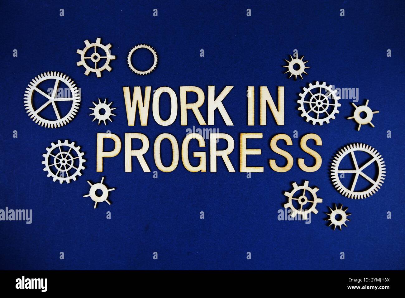 Work In Progress alphabet letters with gears element on navy blue ...