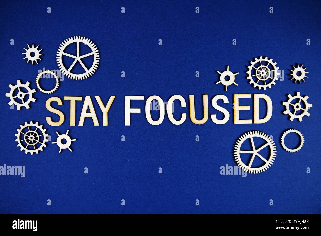 Stay Focused alphabet letters with gears element on navy blue ...