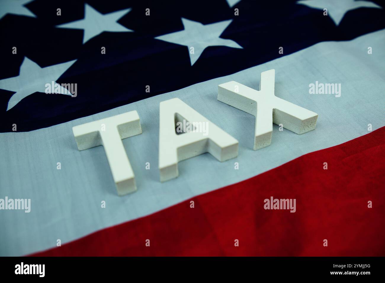 TAX alphabet letters with USA flag background Stock Photo - Alamy