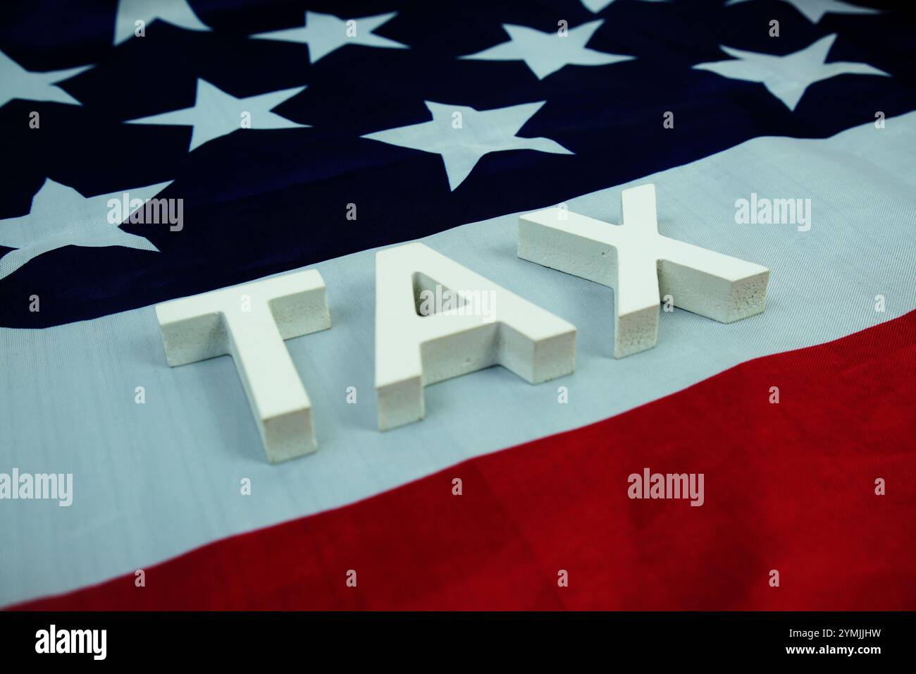 TAX alphabet letters with USA flag background Stock Photo - Alamy