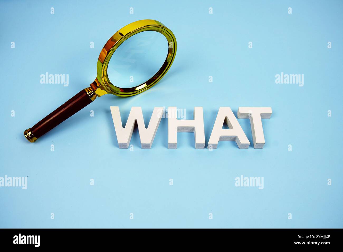 WHAT word with magnifying glass top view on blue background Stock Photo ...