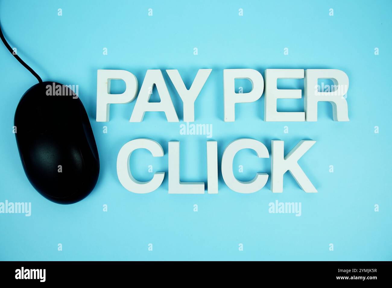 Pay Per Click alphabet letters and optical mouse top view on blue ...