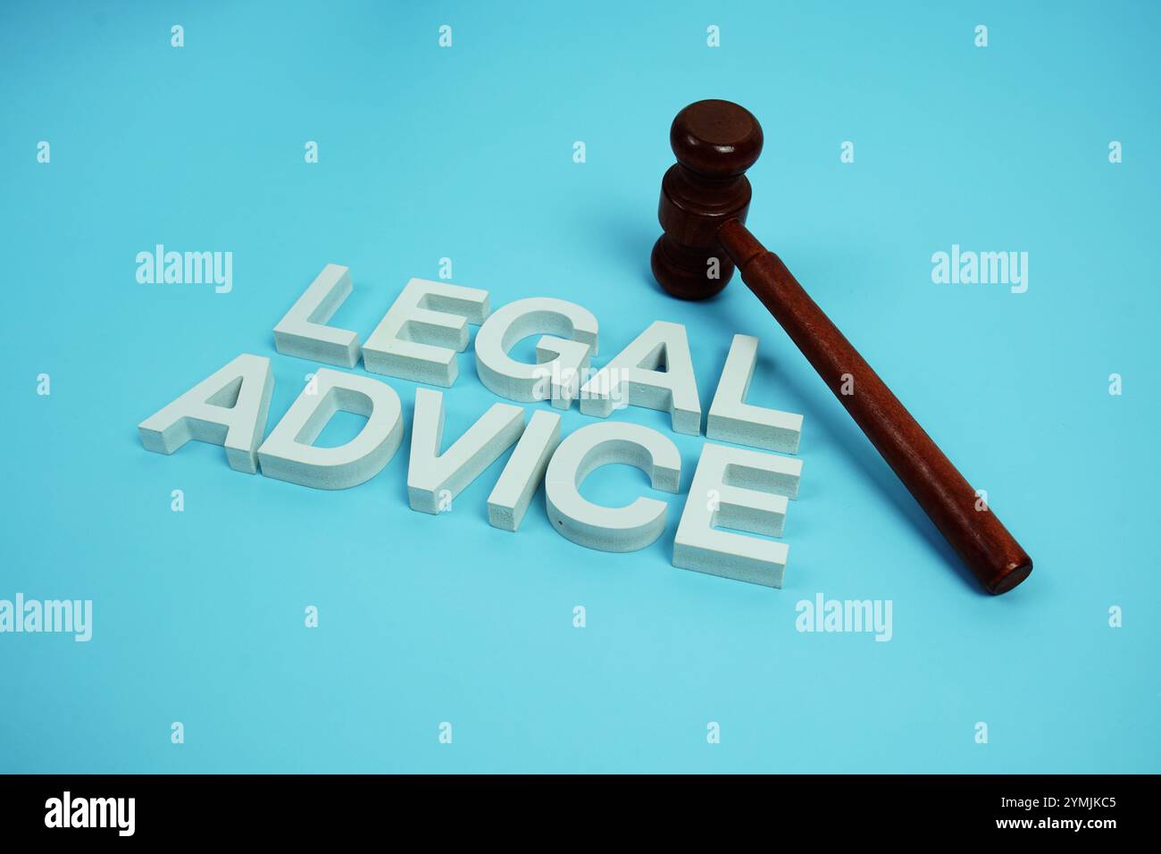 Legal Advice alphabet letters with wooden judge gavel on blue ...