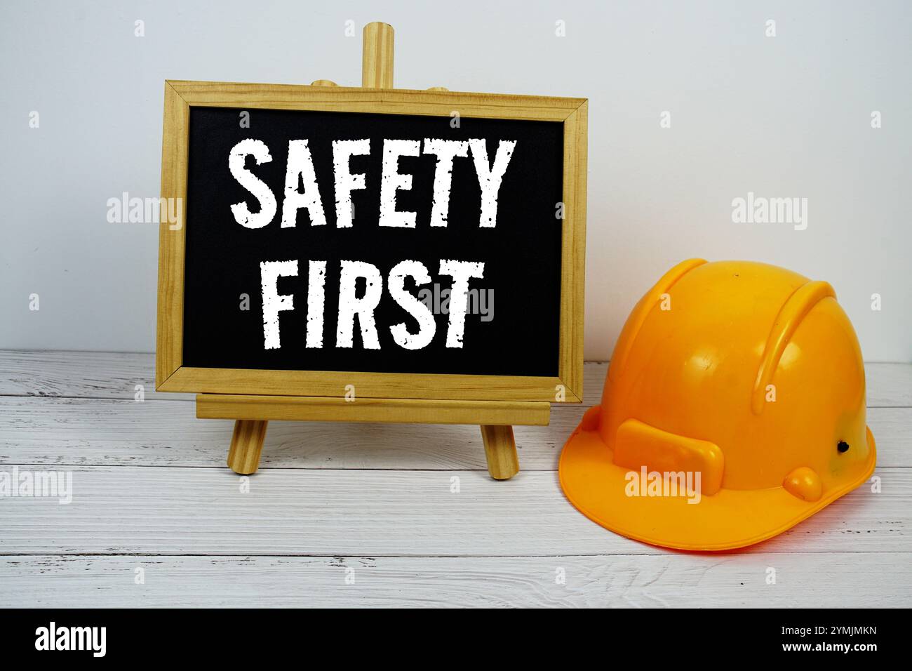 Safety First text on blackboard with safety helmet on wooden background ...