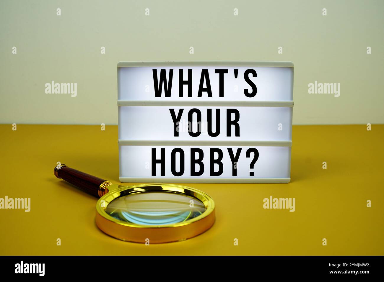 What's Your Hobby? text on LED lightbox with magnifying glass on yellow ...