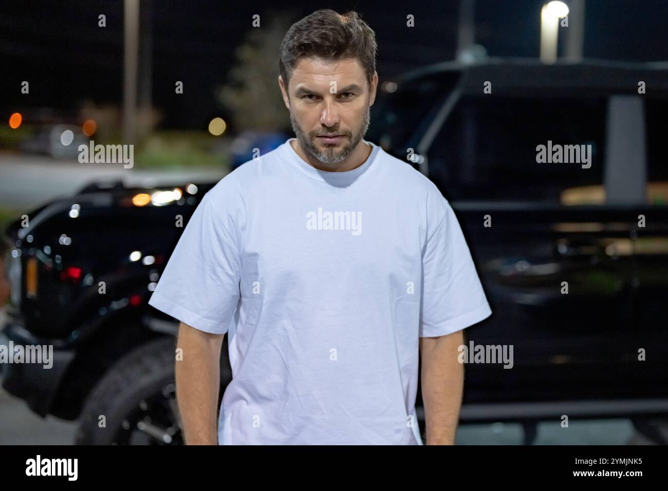 Gangster man. Dangerous angry man near car on night urban street ...