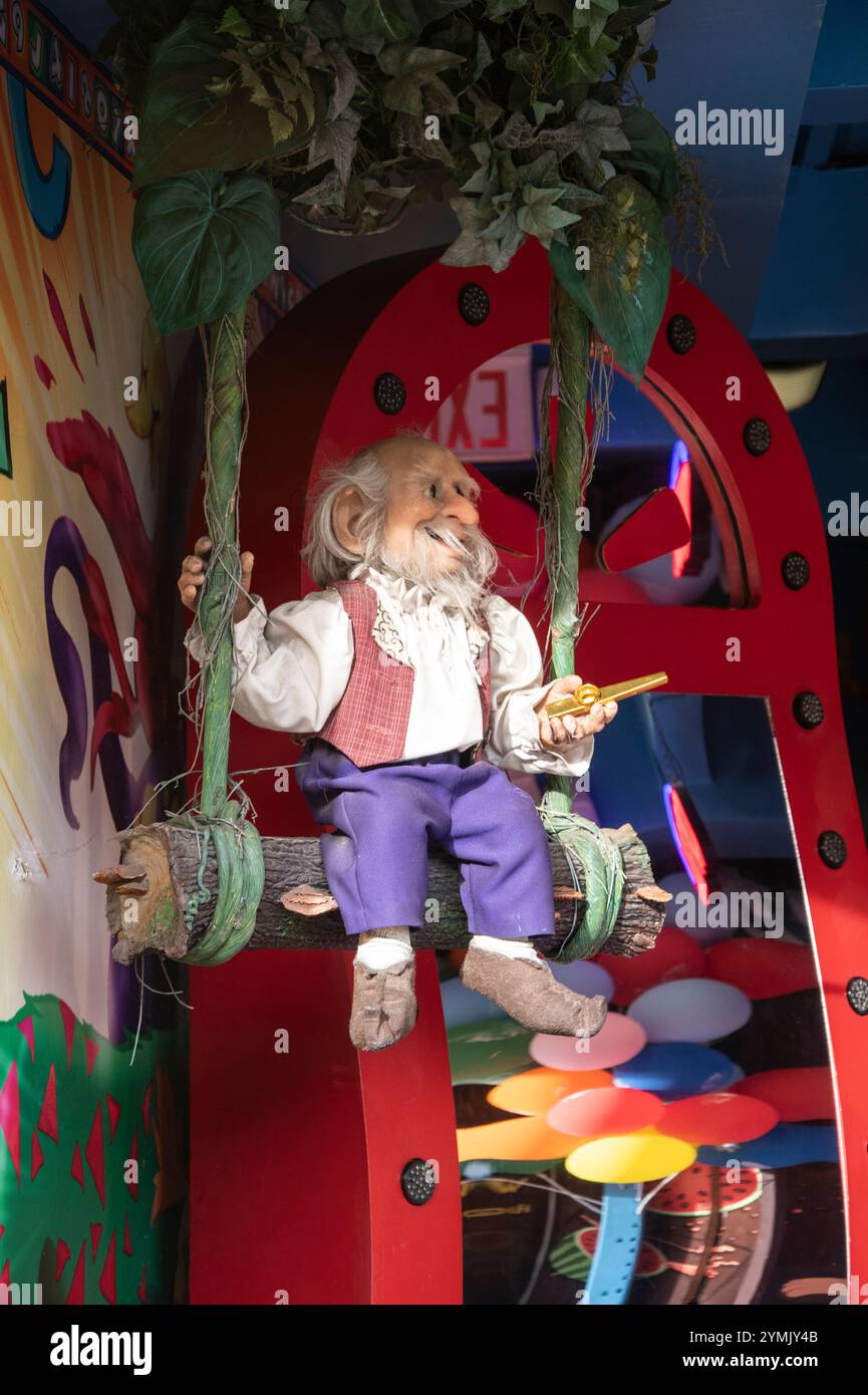 Elf sitting on a swing inside the Fun House on Cliffton Hill in Niagara ...