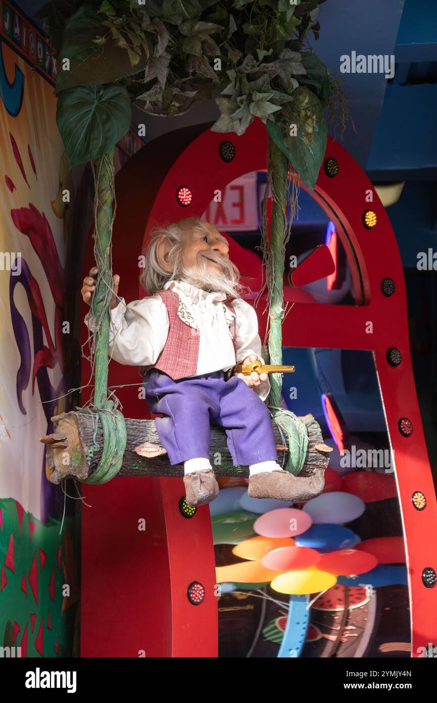 Elf sitting on a swing inside the Fun House on Cliffton Hill in Niagara ...