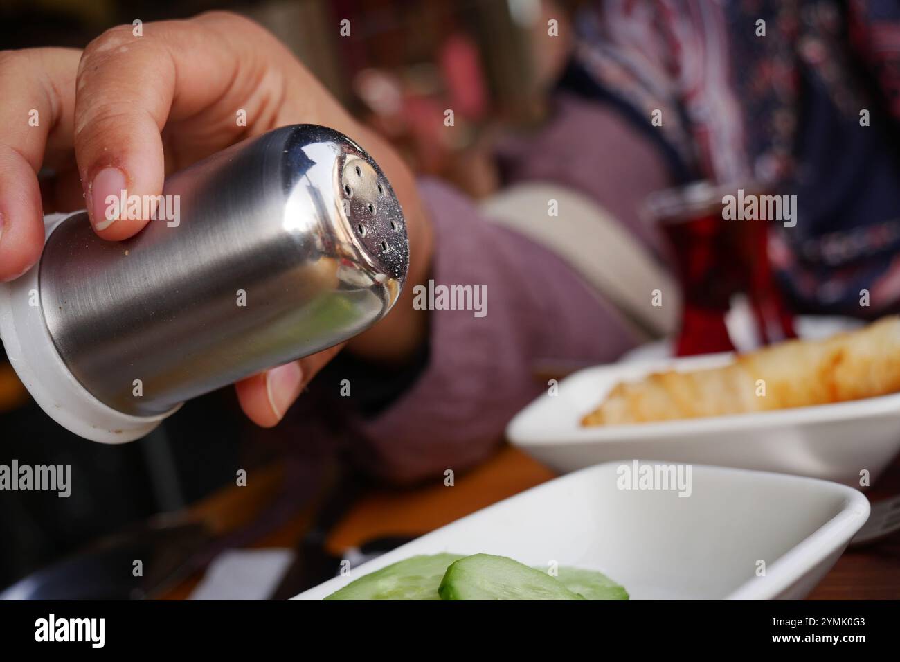 Salt falls from a salt shaker Stock Photo - Alamy