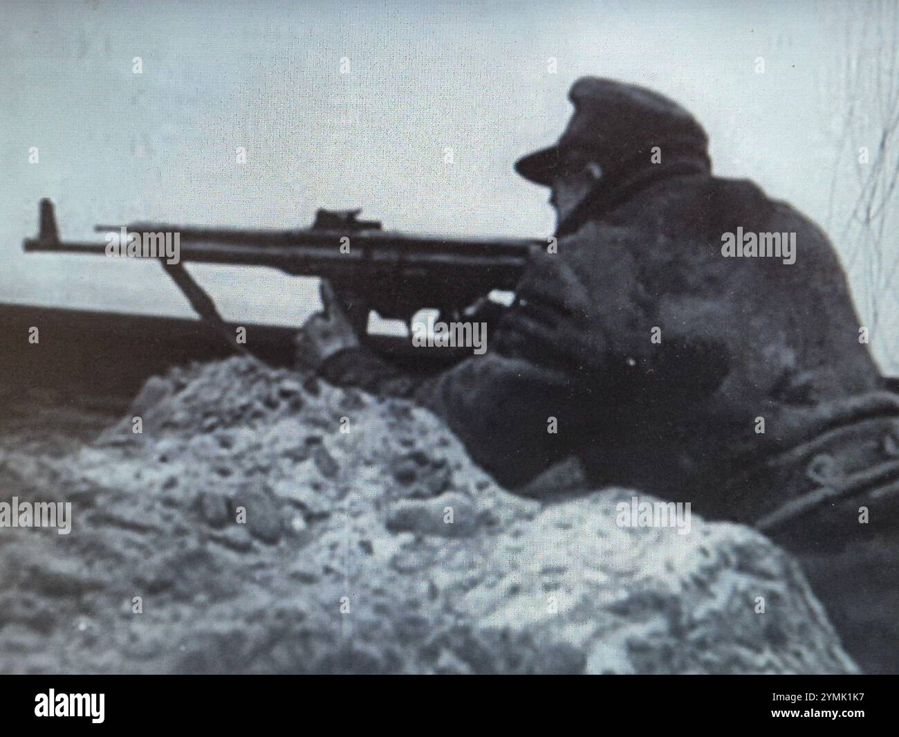 World War Two B&W photo A German Soldier fires his Sturmgewehr 44 or MP44 Assault Rifle from a ...