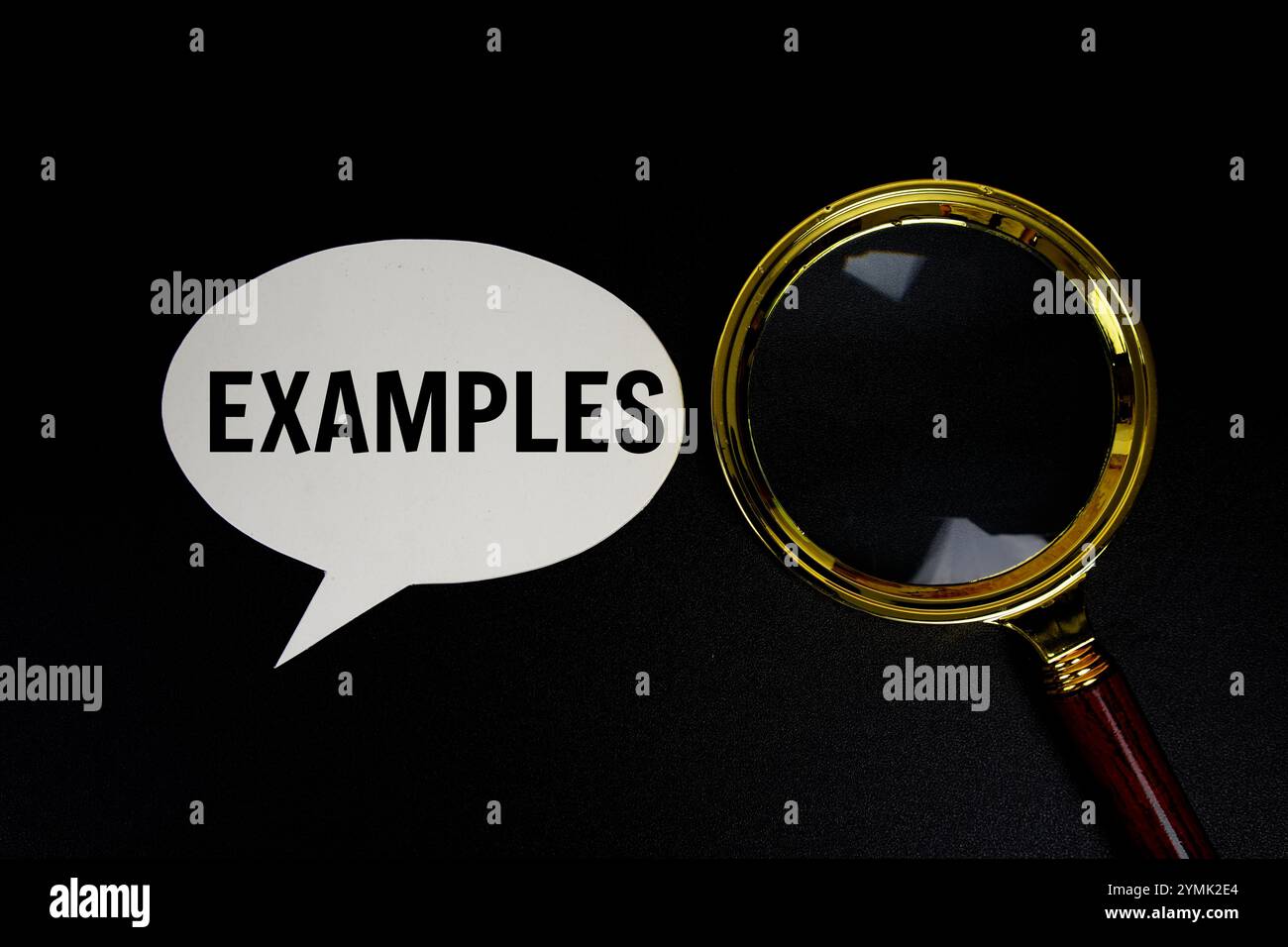 Examples text on speech bubble with magnifying glass top view on black ...
