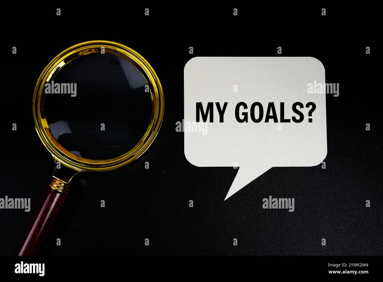 My Goals? text on speech bluble with magnifying glass top view on black ...