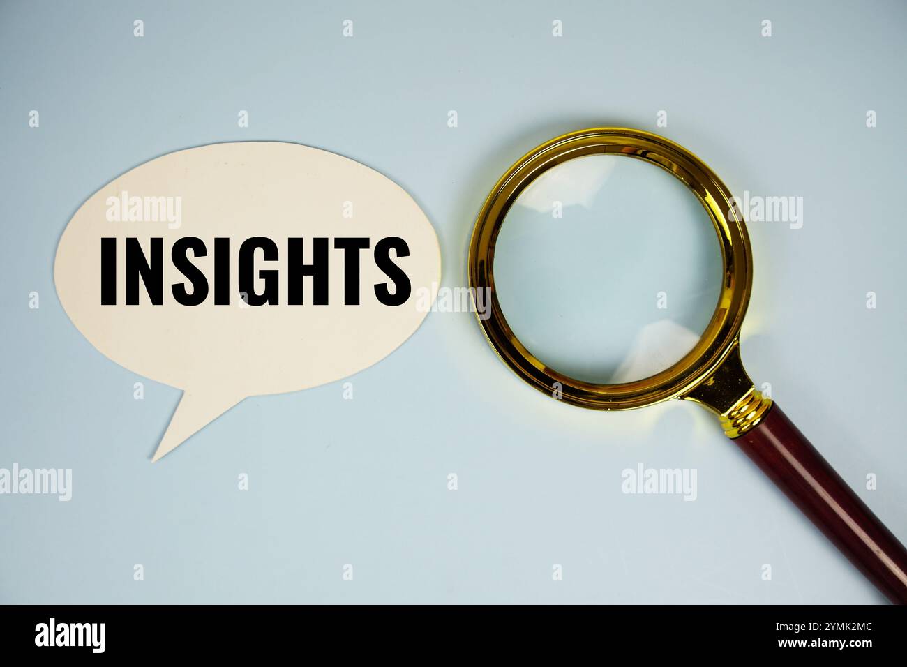 Insights text on speech bubble with magnifying glass top view on blue ...