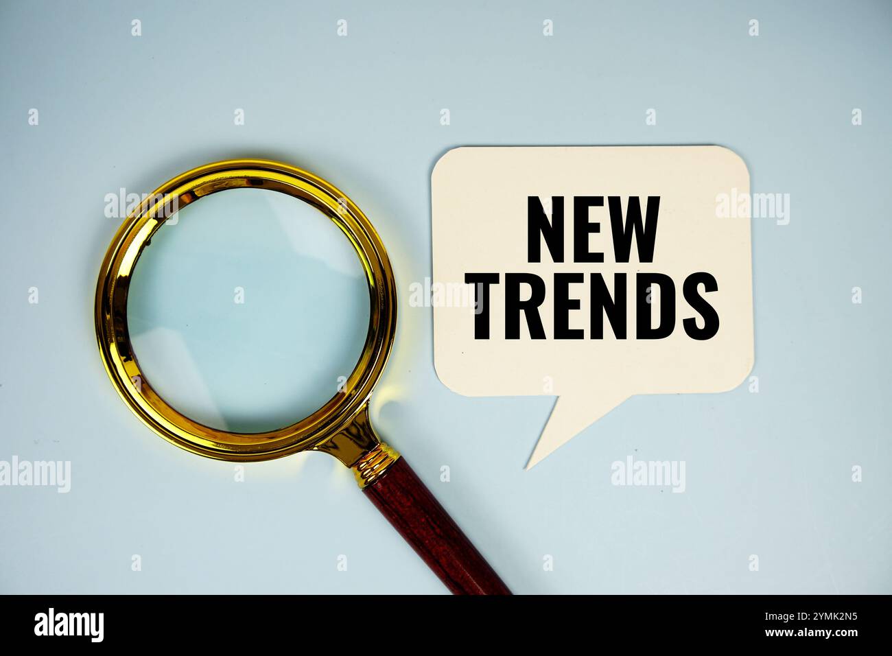 New Trends text on speech bubble with magnifying glass top Stock Photo ...