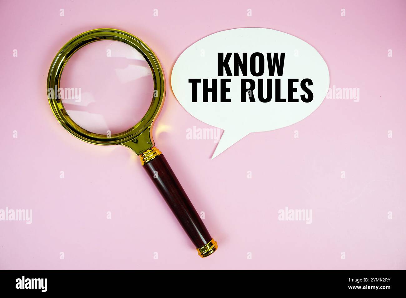 Know the Rules text on speech bluble with magnifying glass top view on ...