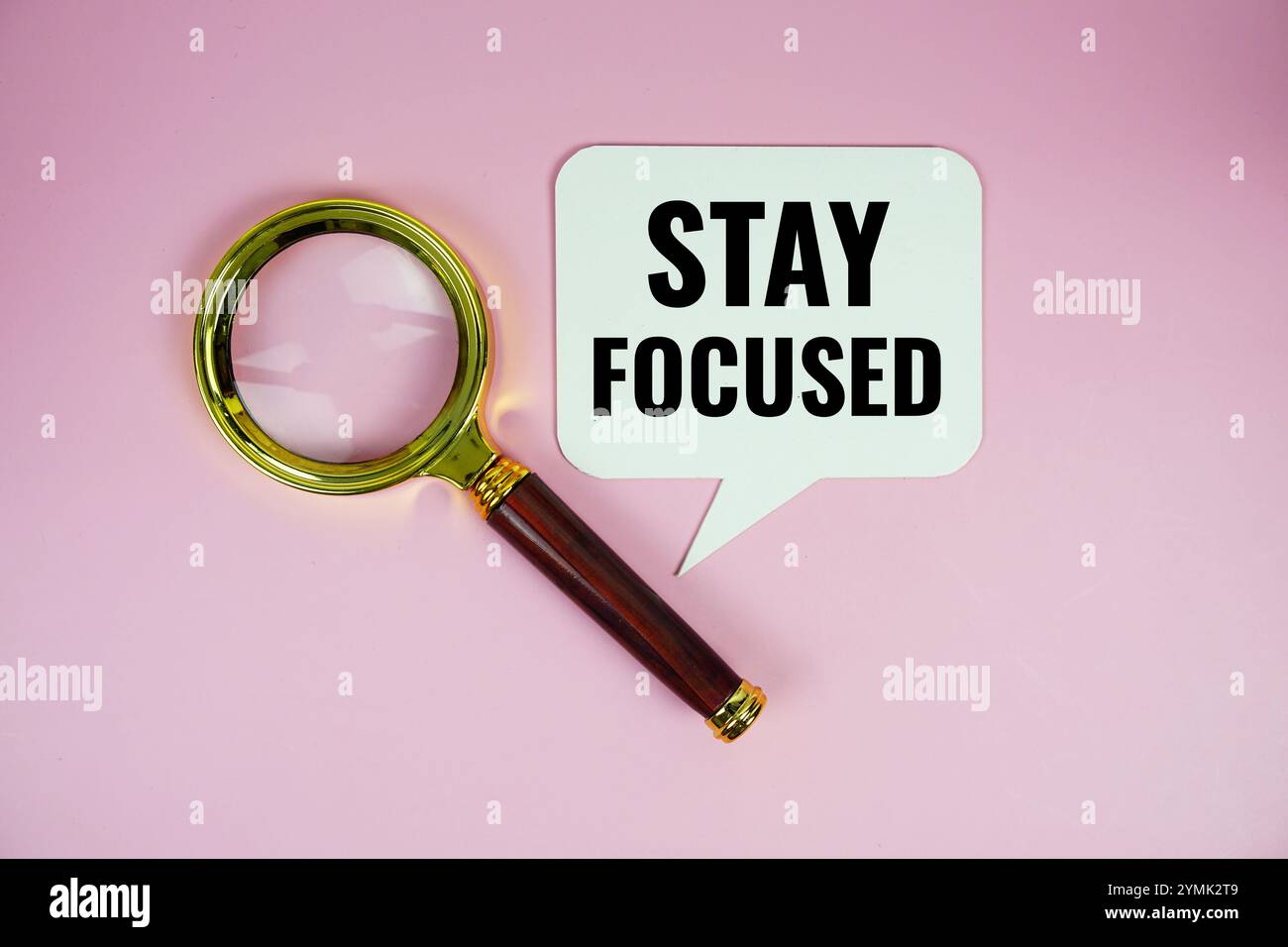Stay Focused text on speech bubble with magnifying glass top view on ...