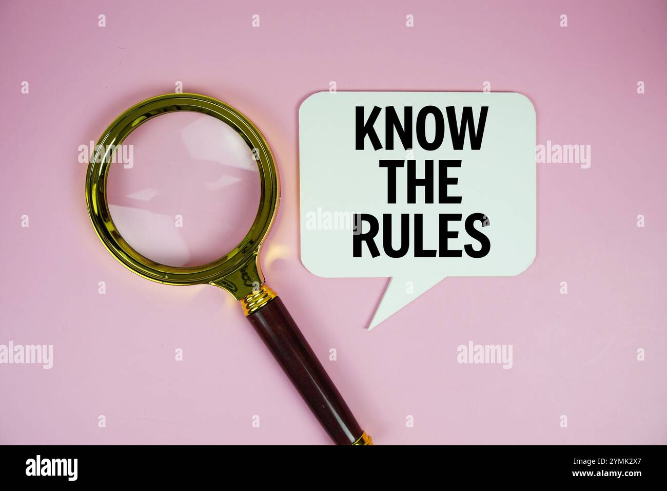 Know the Rules text on speech bluble with magnifying glass top view on ...