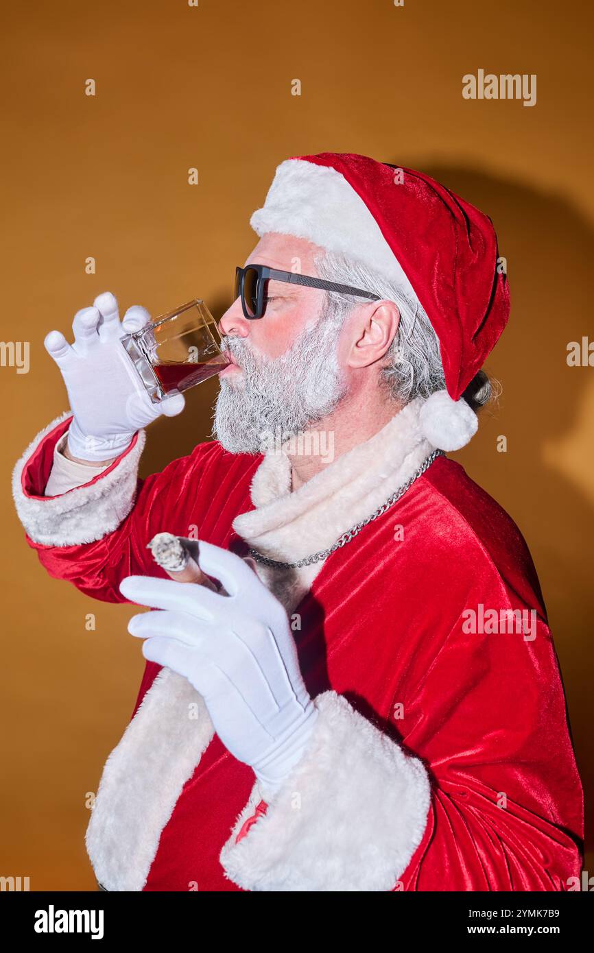 Santa Claus in traditional red suit and hat, wearing sunglasses while ...