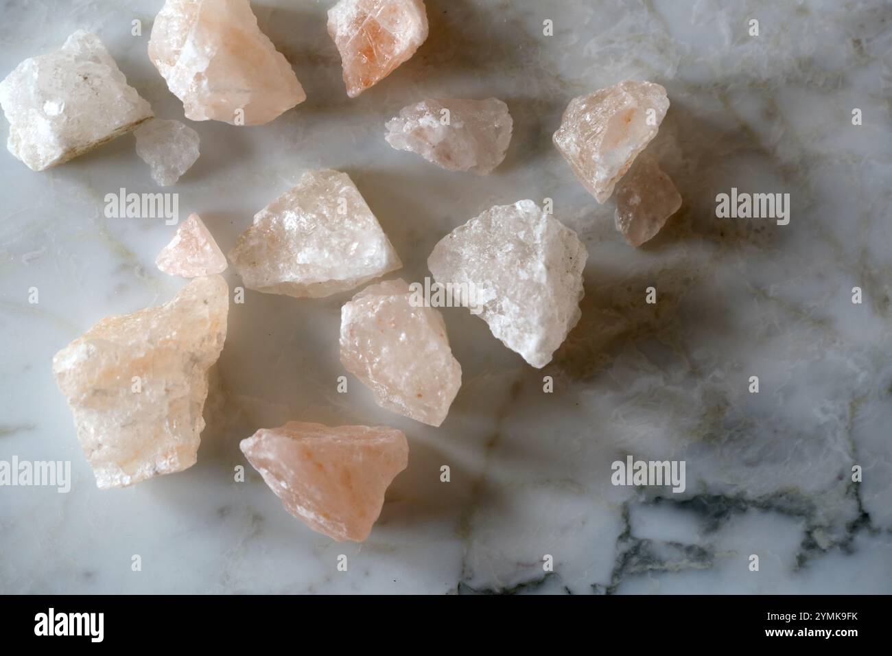 Pink Himalayan rock salt crystals on a marble kitchen counter Stock ...