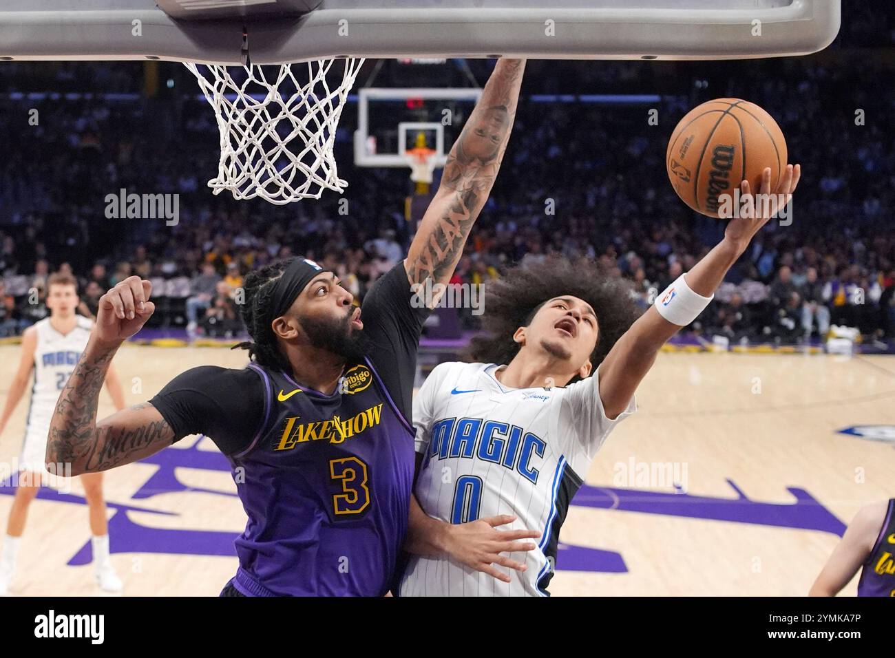 Orlando Magic guard Anthony Black, right, shoots as Los Angeles Lakers ...