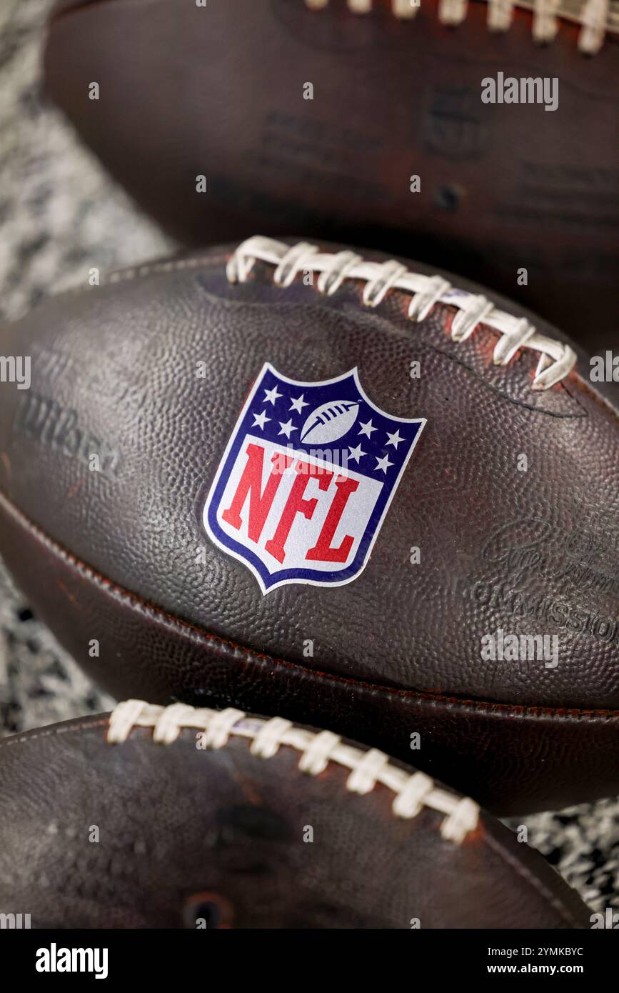 The NFL shield logo on a game ball before an NFL football game between ...