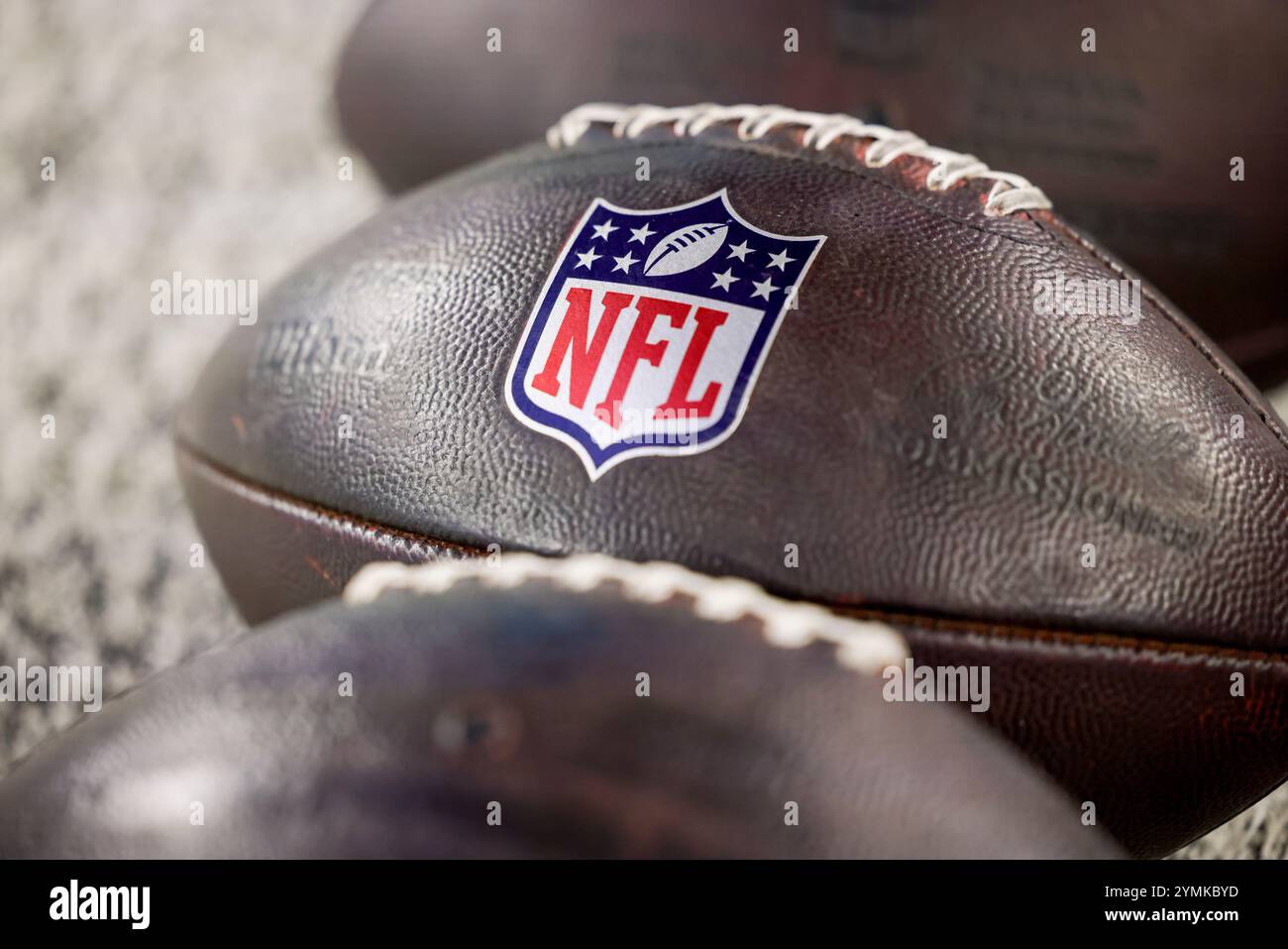 The NFL shield logo on a game ball before an NFL football game between ...