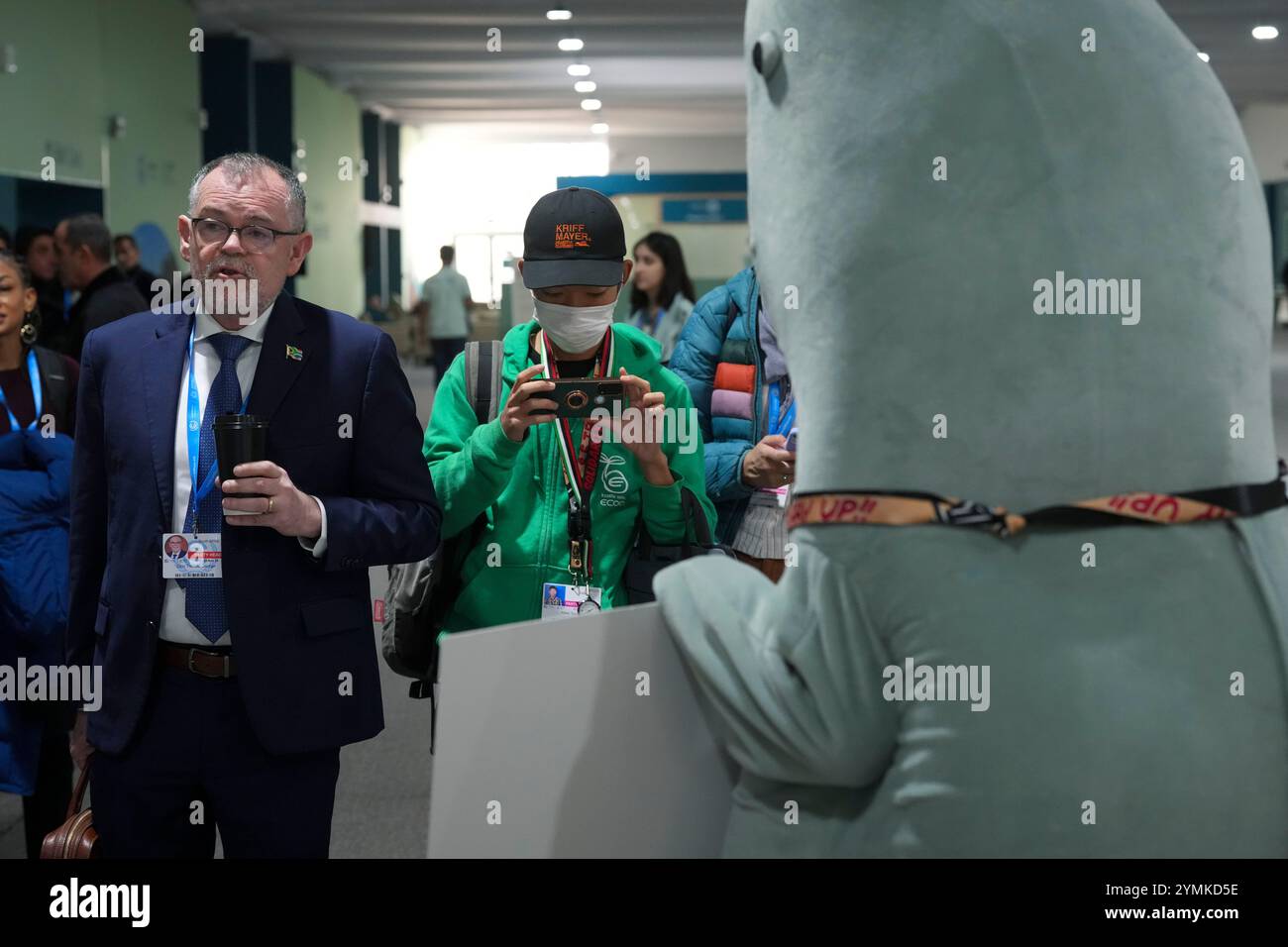 Dion George, South Africa environment minister, left, walks past a ...