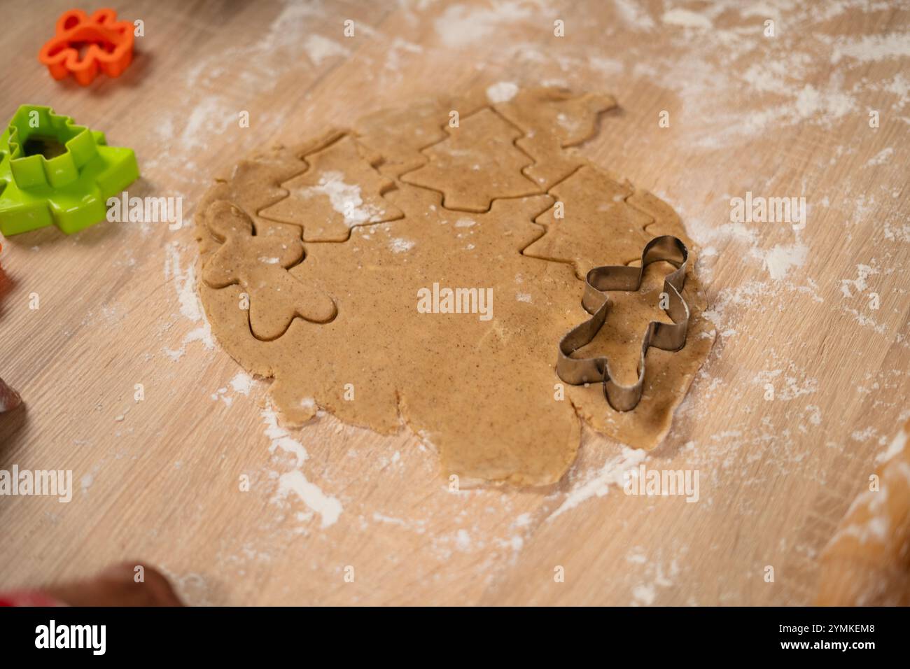 Gingerbread cookie dough cut into gingerbread men and tree Stock Photo ...