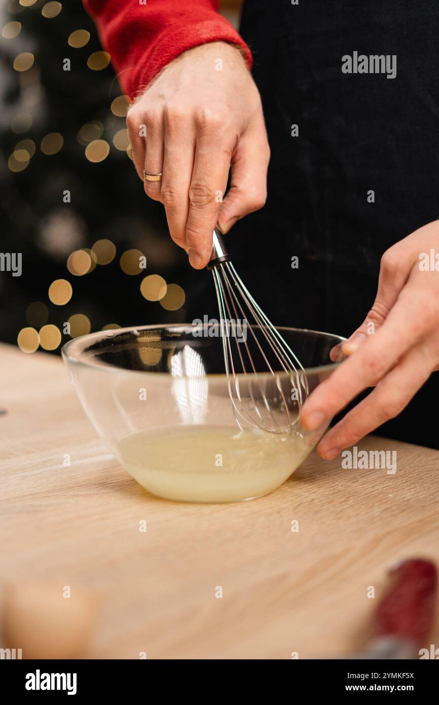 Hand Whisking Ingredients in Glass Bowl for Baking Stock Photo - Alamy