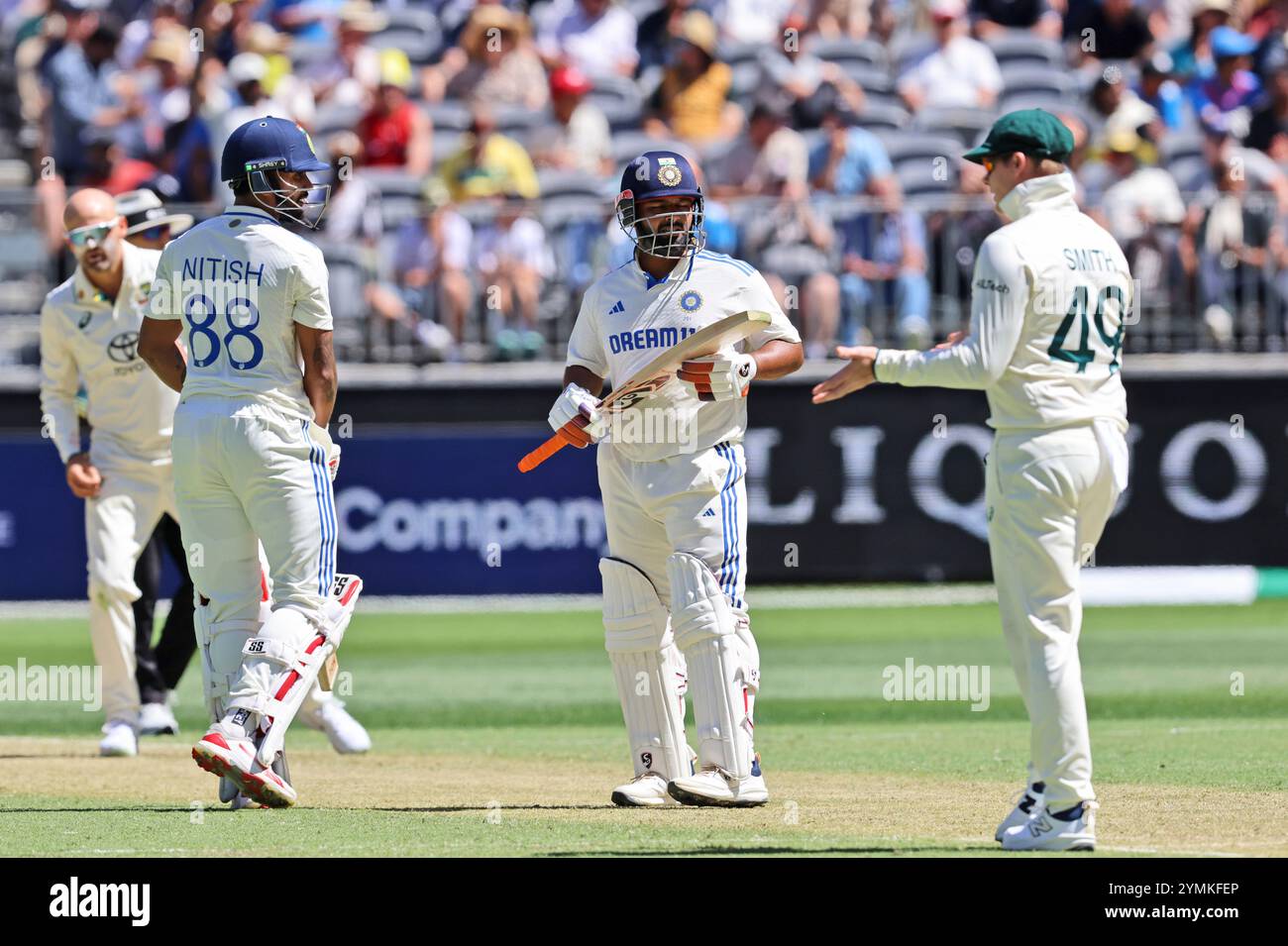Australia's Steve Smith, right, gestures to India's Nitish Kumar Reddy ...