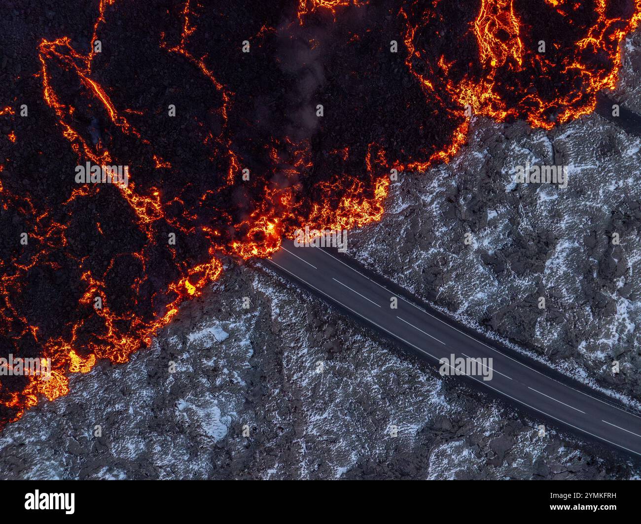 Molten lava flows on the road to the Blue Lagoon, Grindavik, after the ...