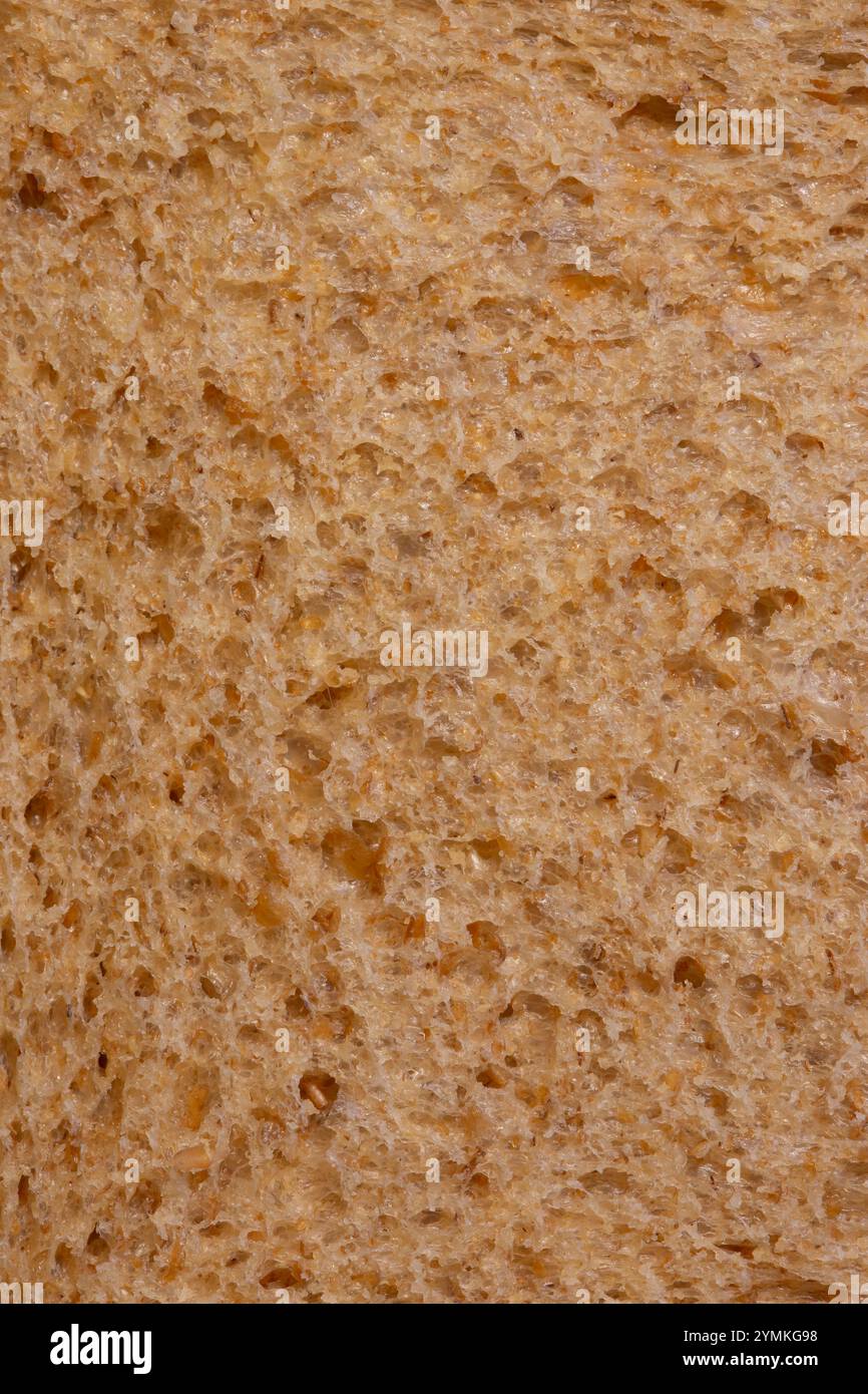 Slice of wholemeal brown bread background backdrop close up. Healthy ...