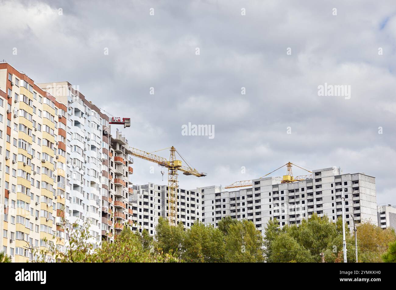 Tower crane building a house. Concrete building under construction ...