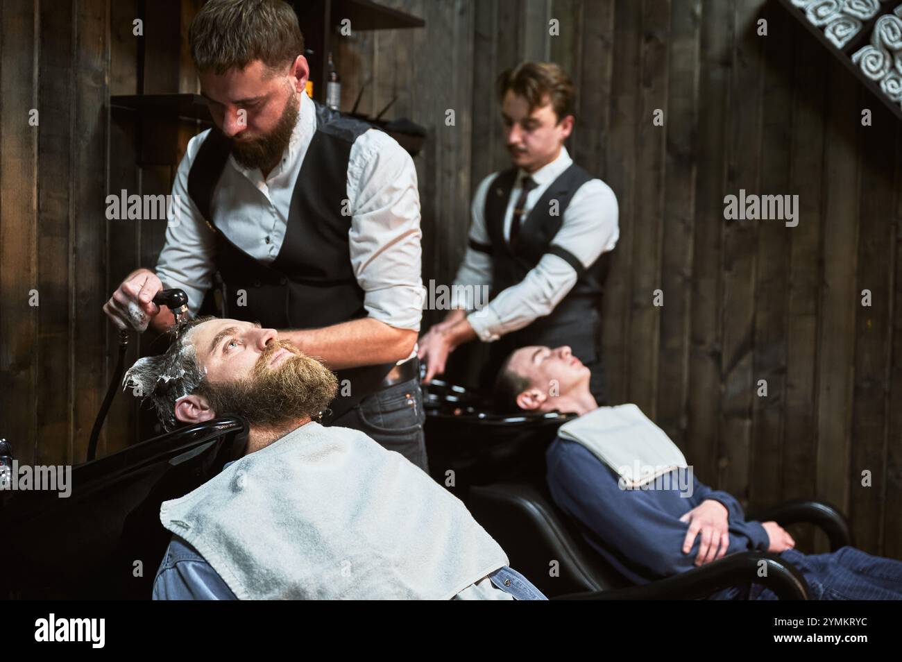 Professional barbers washing hair hi-res stock photography and images ...