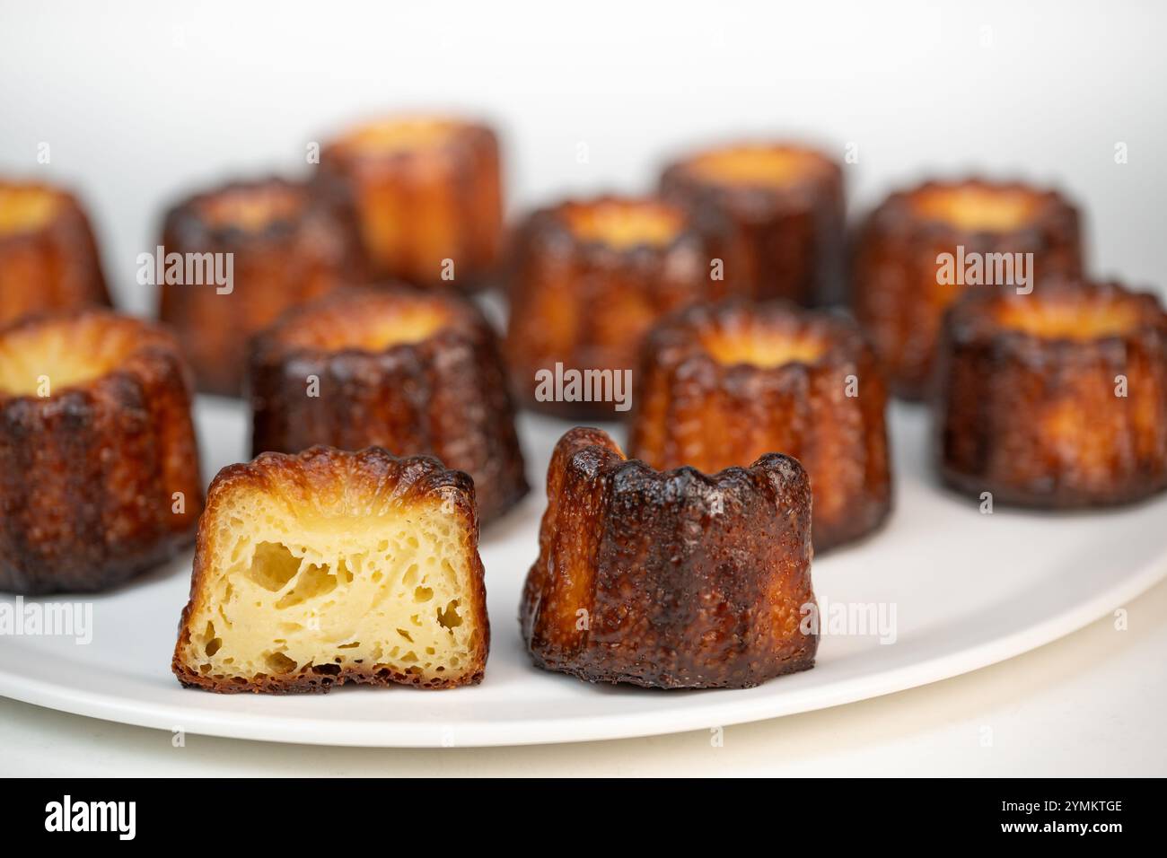 Canneles de bordeaux, traditional French sweet dessert with white table ...