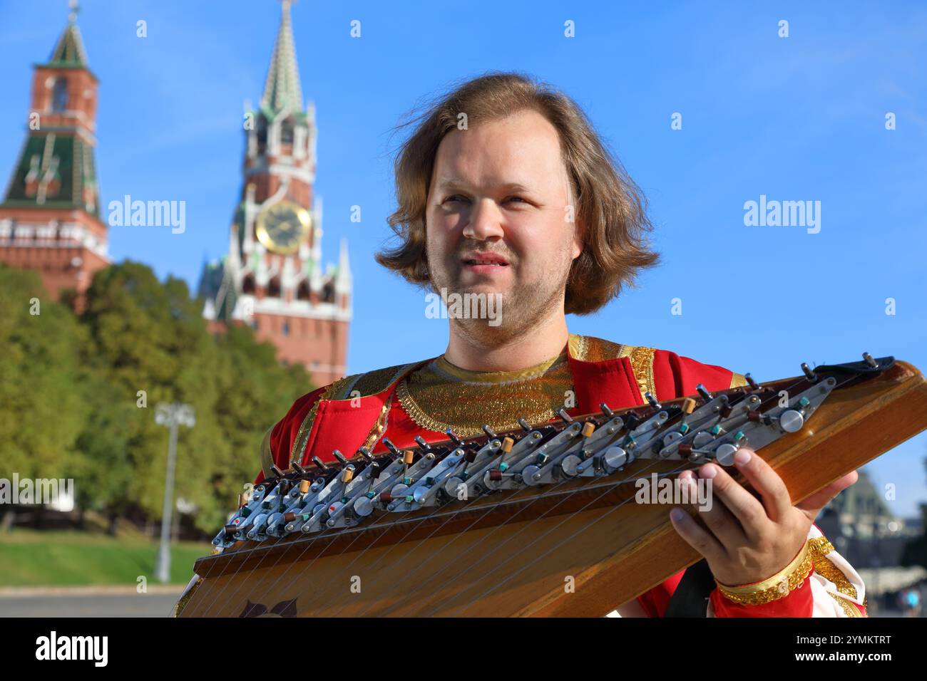 Portrait of a musician in traditional Russian clothes with an old ...