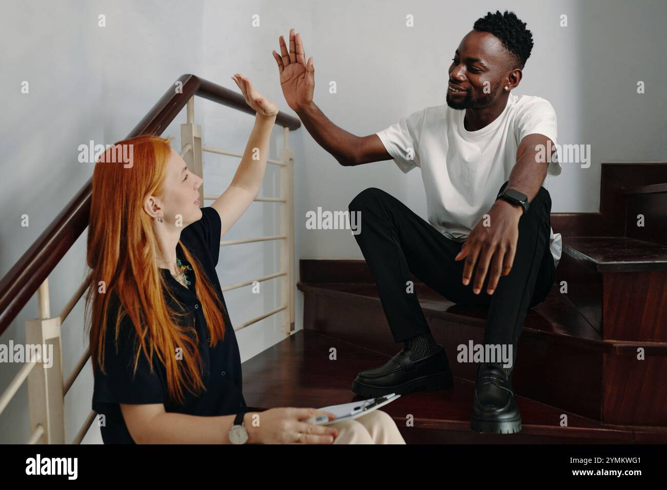 Celebrating Successful Teamwork with High Five Indoors Stock Photo - Alamy
