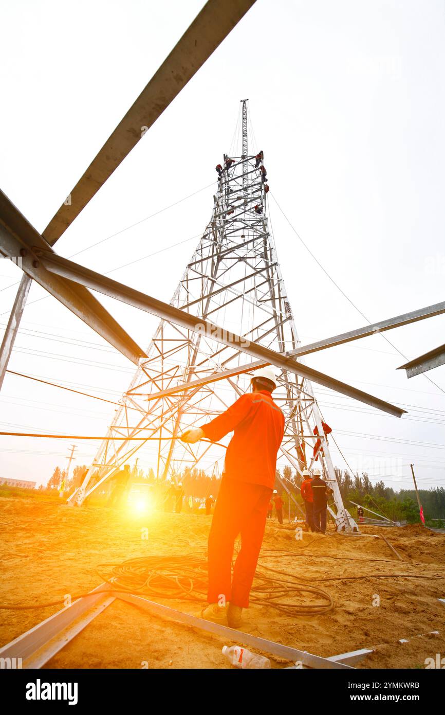 The workers of the pylon Stock Photo - Alamy