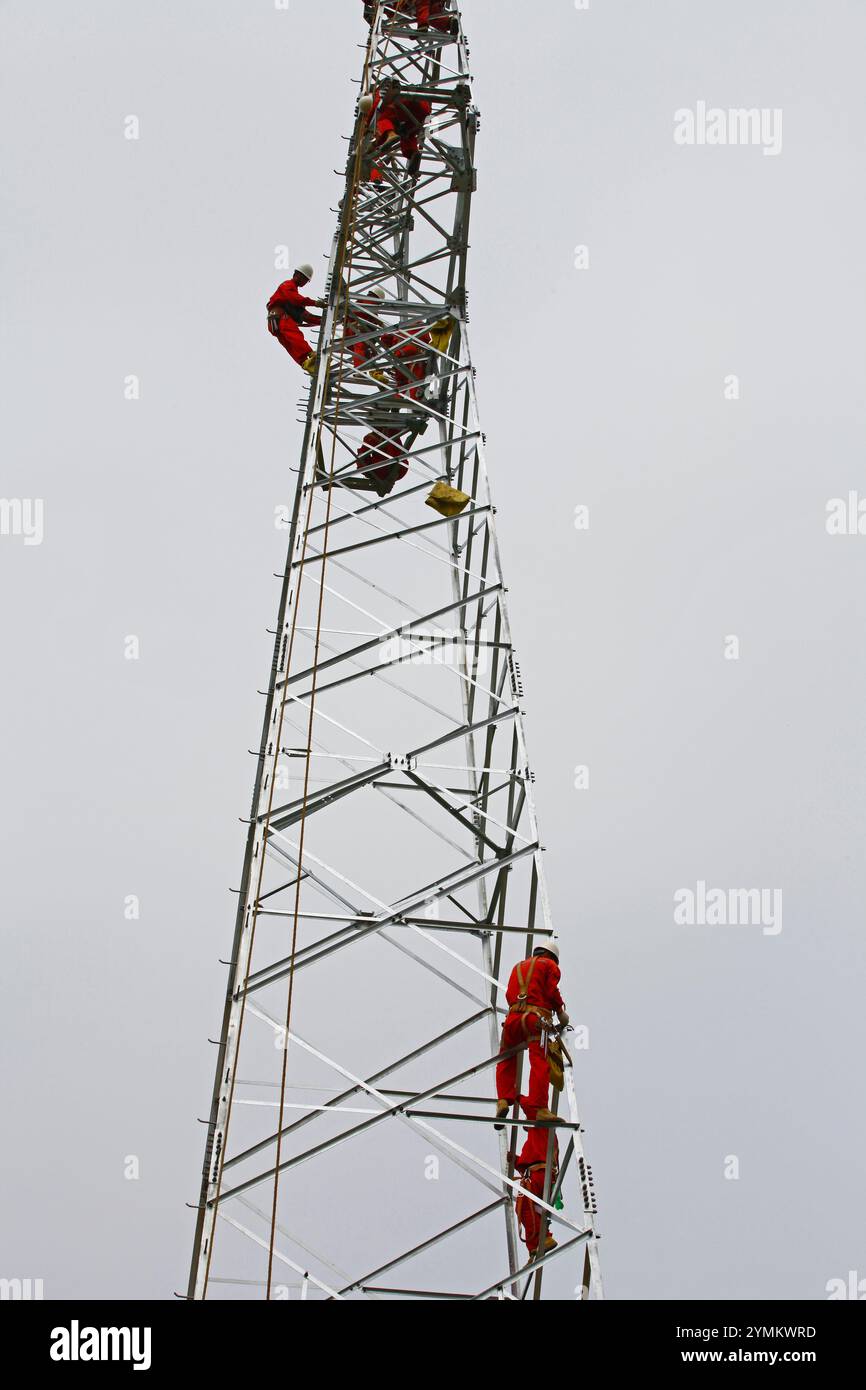 The workers of the pylon Stock Photo - Alamy
