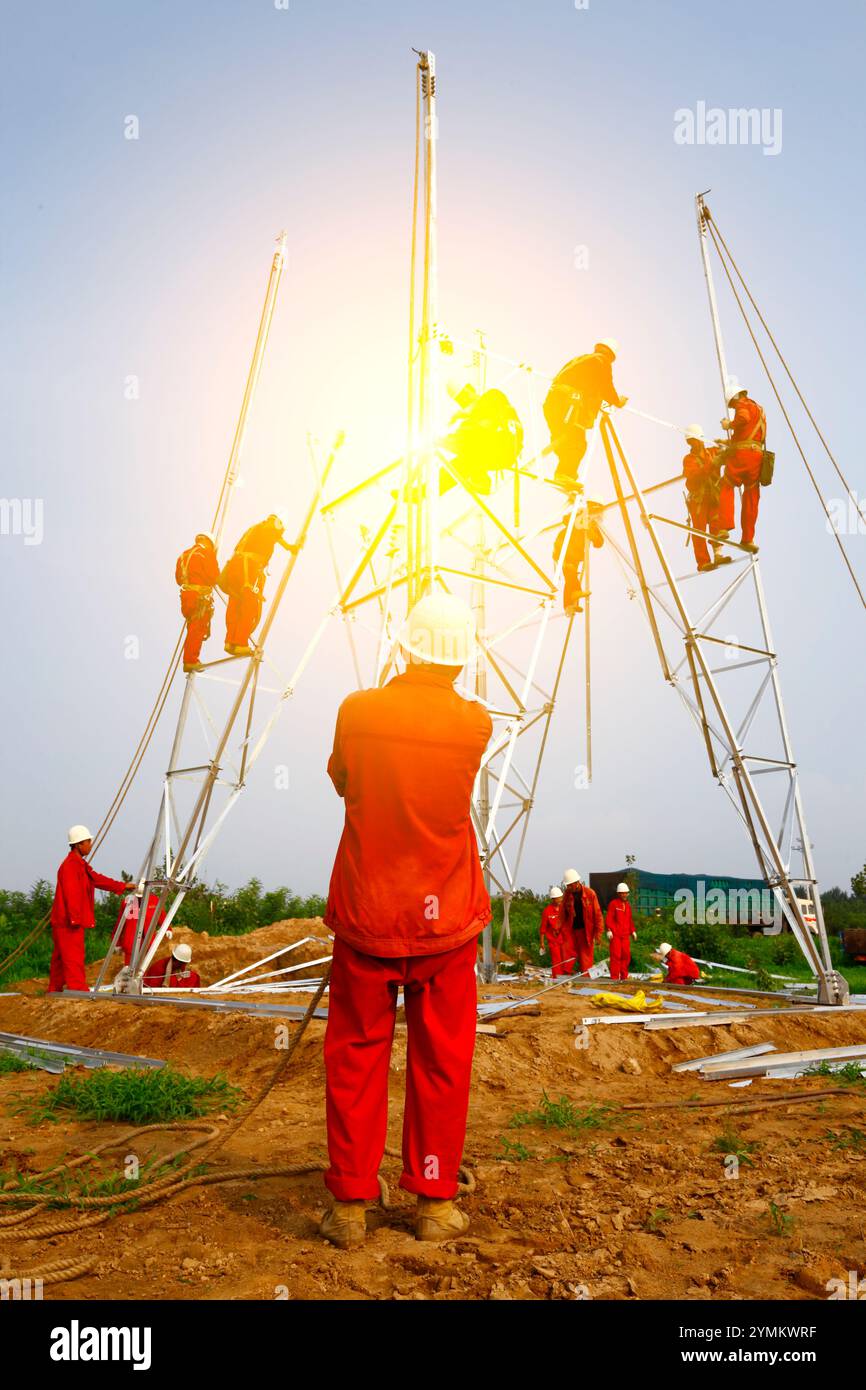 The workers of the pylon Stock Photo - Alamy