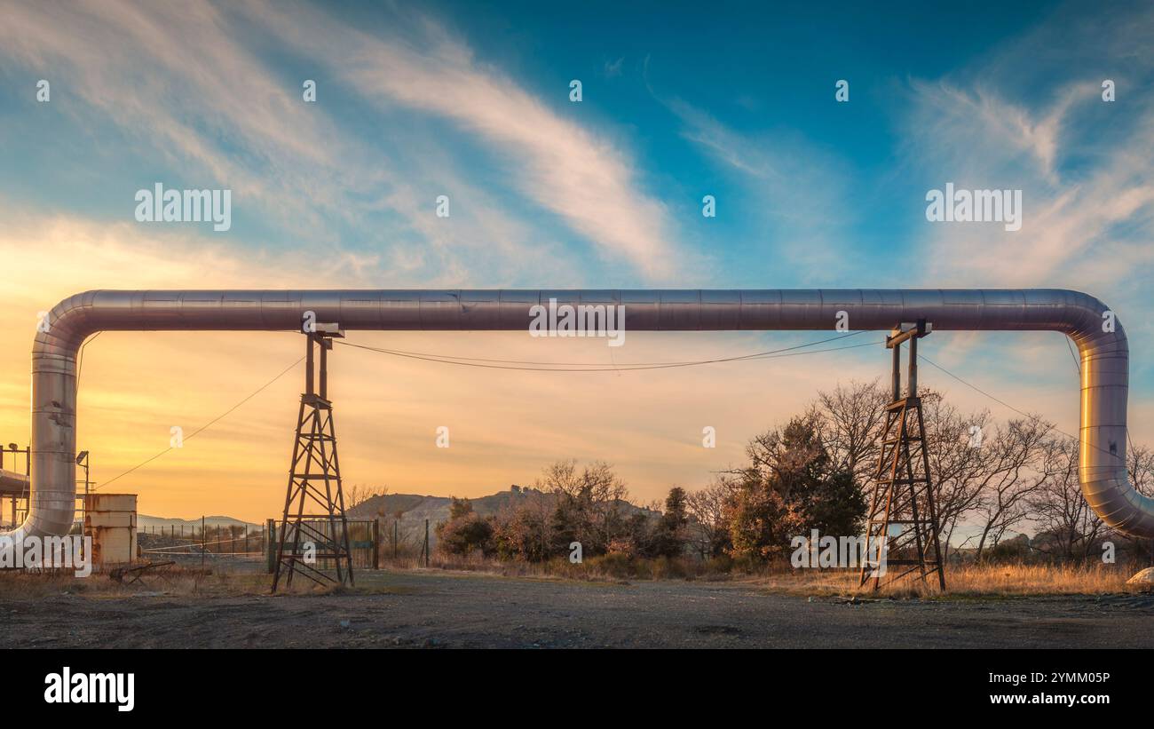 Pipeline of a geothermal power plant at sunset in Larderello, Tuscany ...