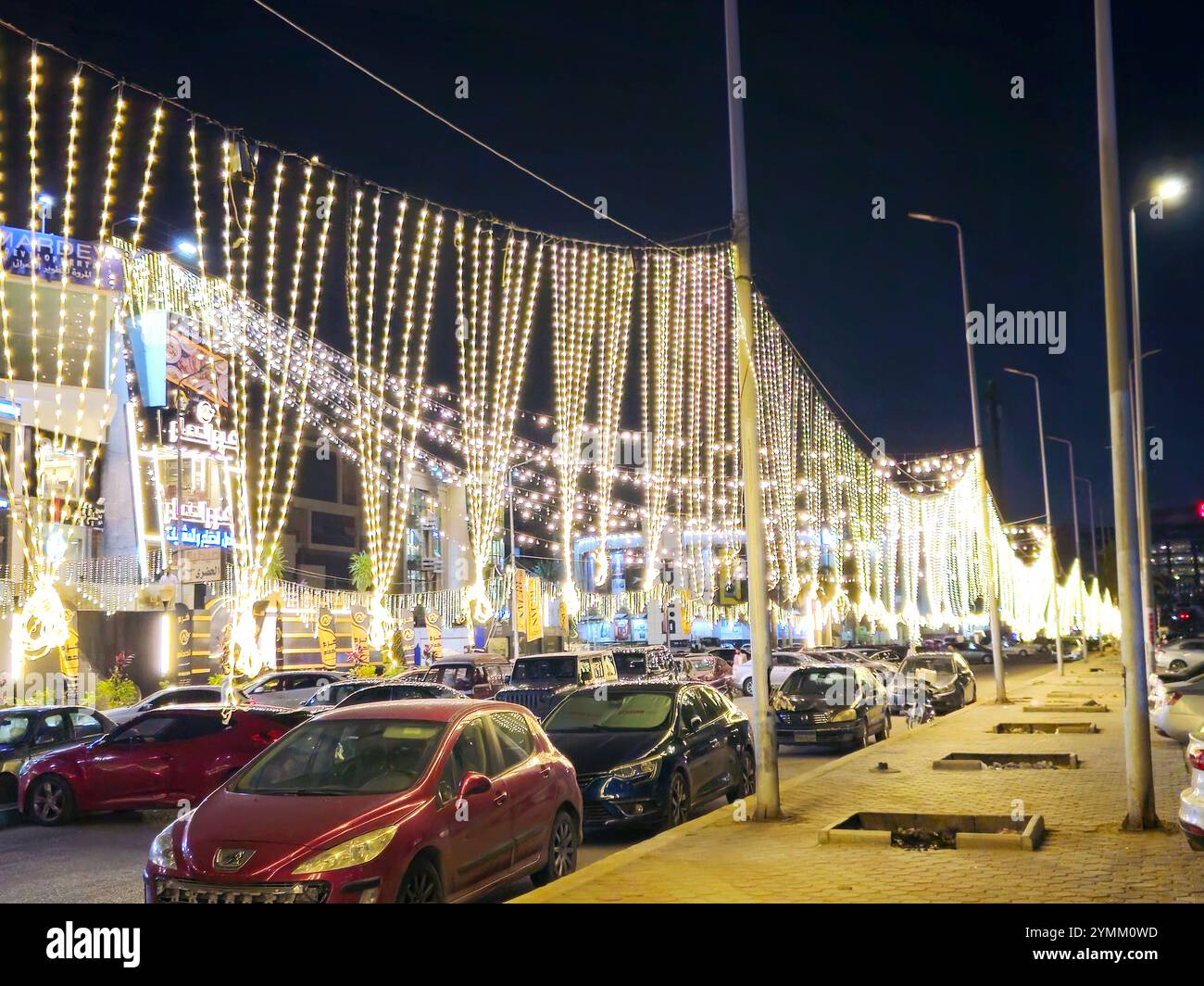 Cairo, Egypt, November 13 2024: lots of celebration lights in new Cairo city street at night ...
